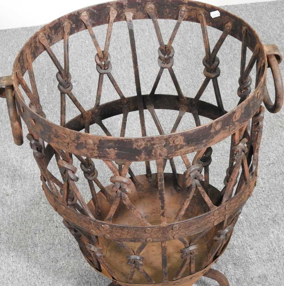 Lot 92 - A wrought iron log basket