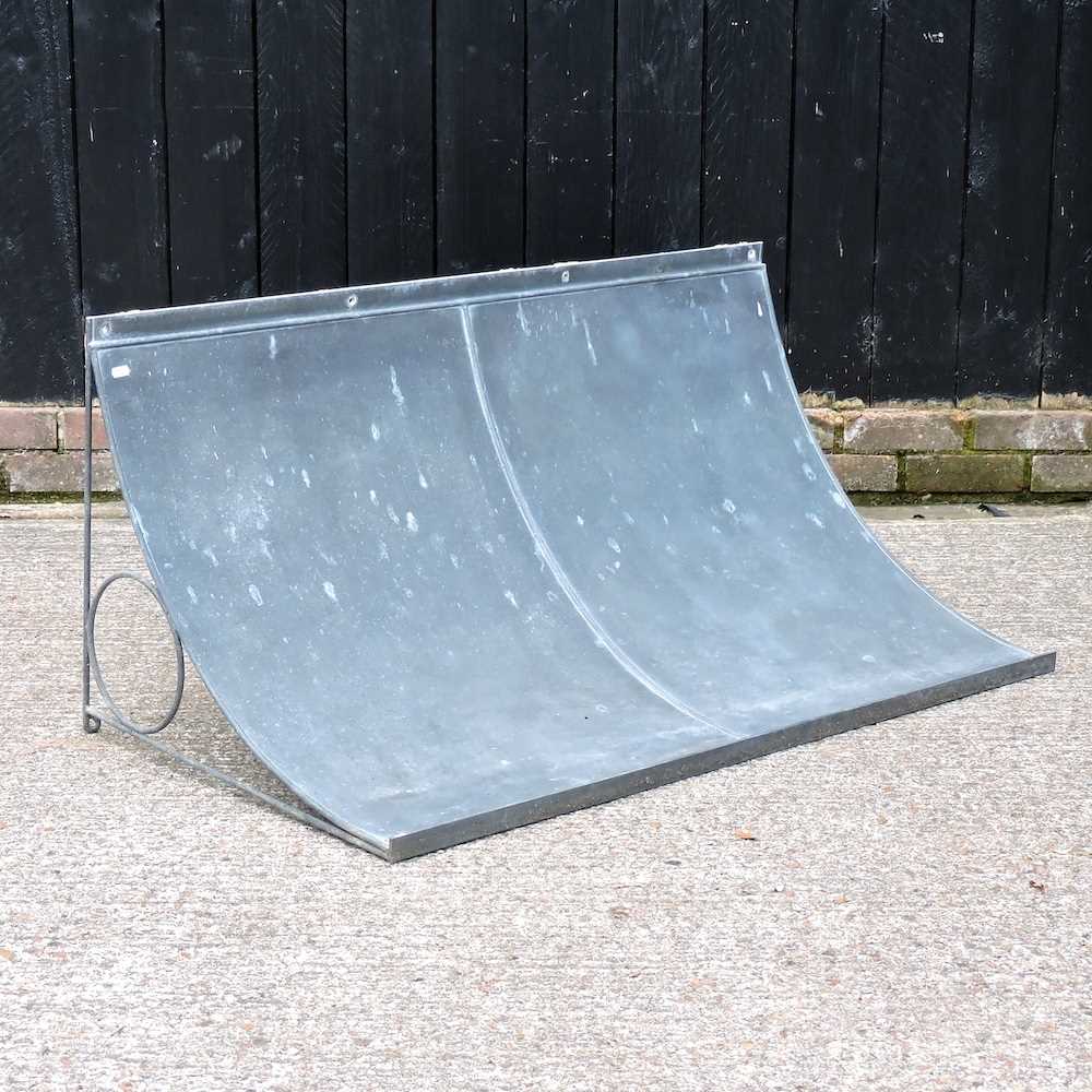 Lot 11 - A galvanised zinc porch door canopy, from
