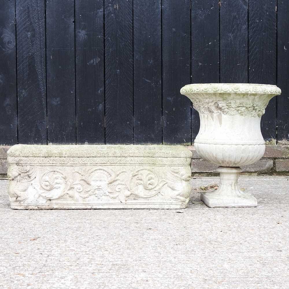 Lot 534 - A cast stone garden trough and urn