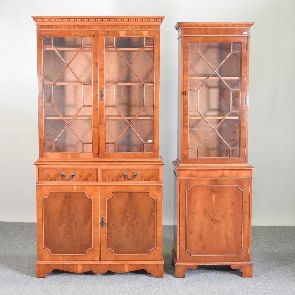 Lot 812 - A reproduction yew wood cabinet bookcase,