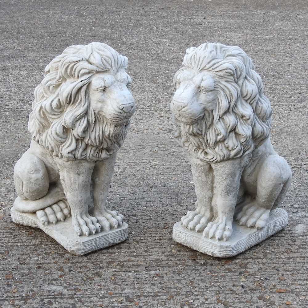 Lot 401 - A pair of cast stone garden statues of