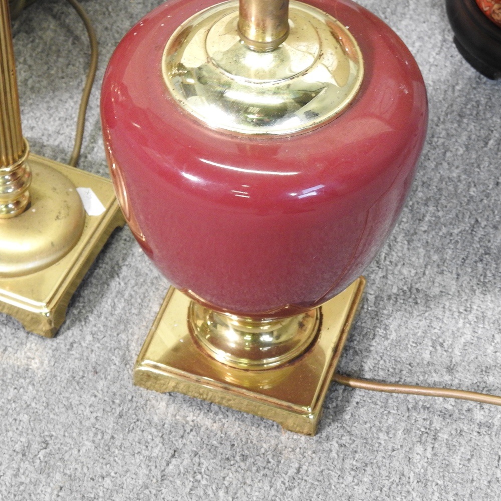 Lot 865 - A pair of red pottery table lamps and shades,