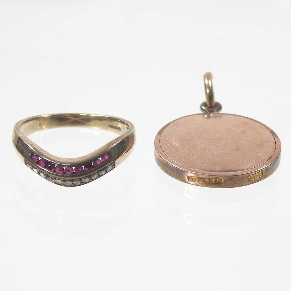 Lot 434 - A 9 carat gold ruby and diamond channel set