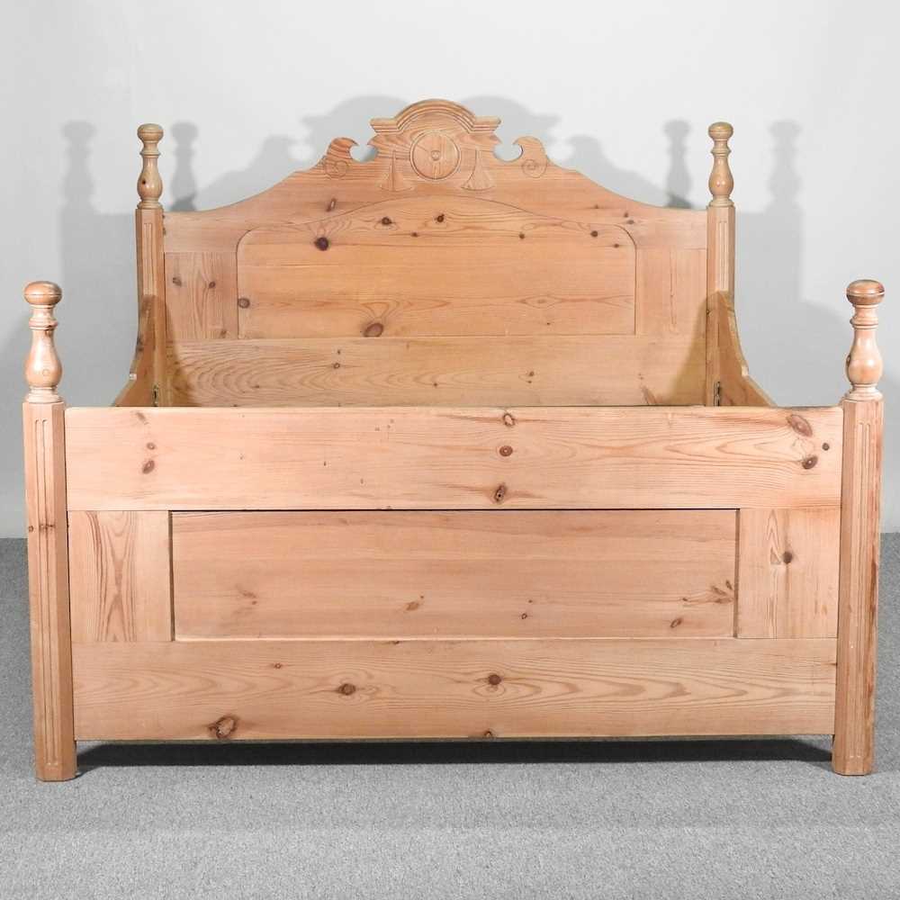 Lot 254 - An antique pine bedstead, with a slatted