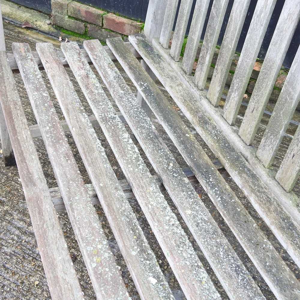 Lot 212 - A teak slatted wooden garden bench