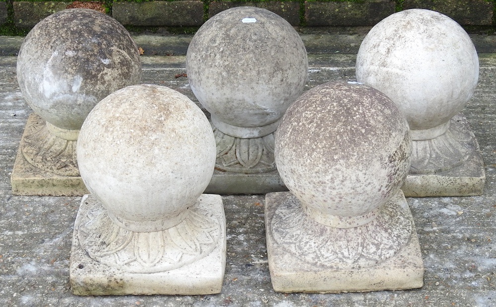 Lot 1 - A collection of five cast stone ball markers,