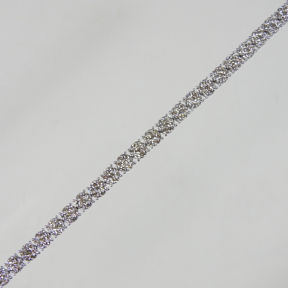 Lot 413 - A 9 carat white gold diamond set line