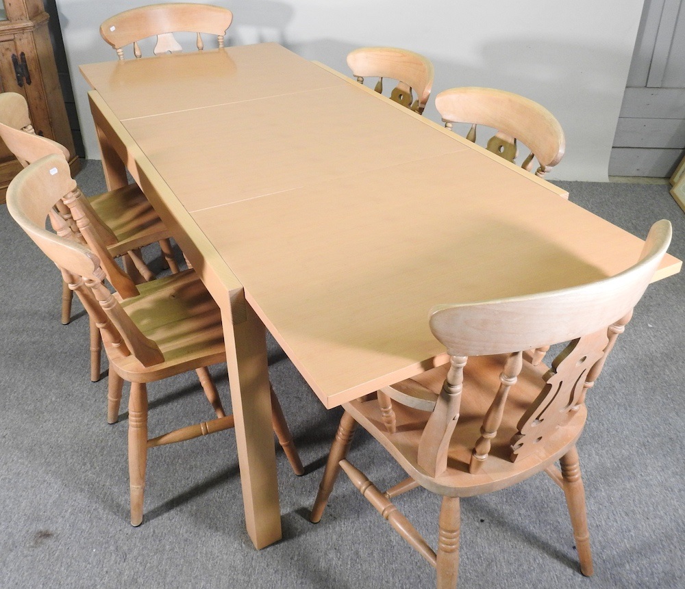 Lot 513 - A modern extending dining table, together