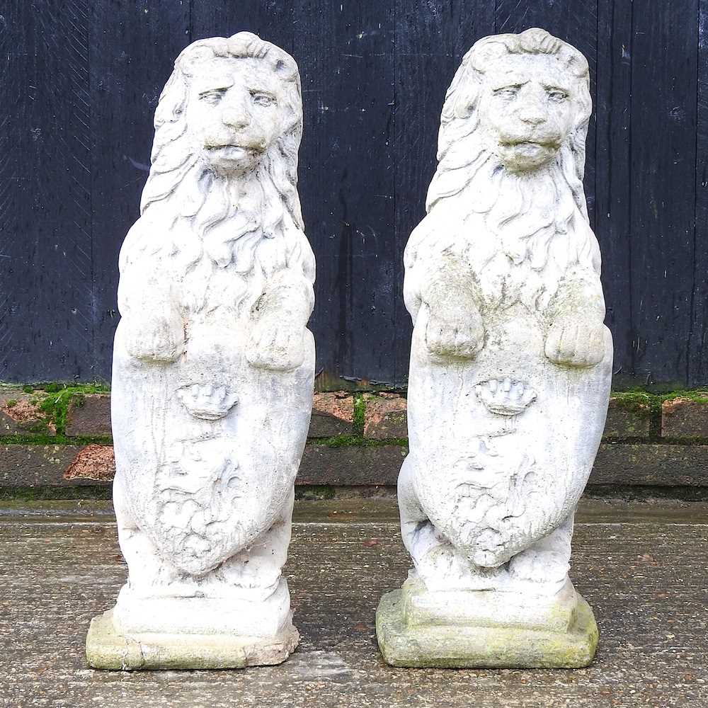 Lot 508 - A pair of cast stone garden statues of lions,
