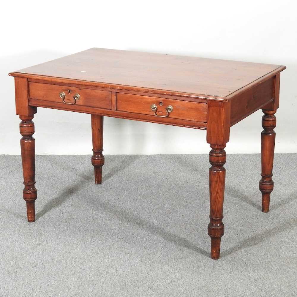 Lot 125 - An early 20th century pine writing table, on
