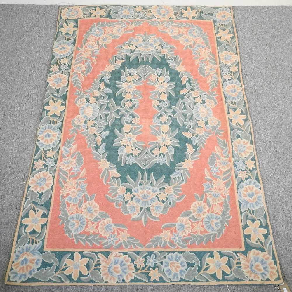 Lot 487 - A wool chain rug, with floral decoration,