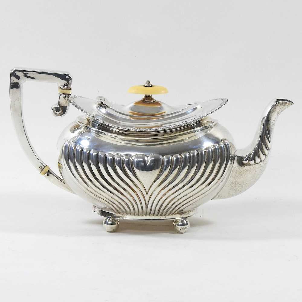 Lot 122 - An Edwardian silver teapot, with a half