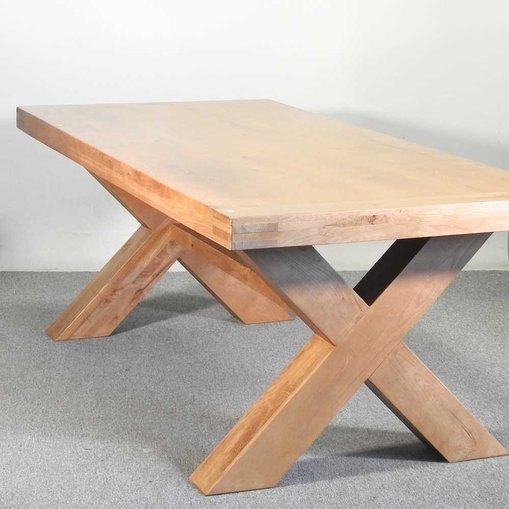Lot 86 - A modern light oak dining table, on an