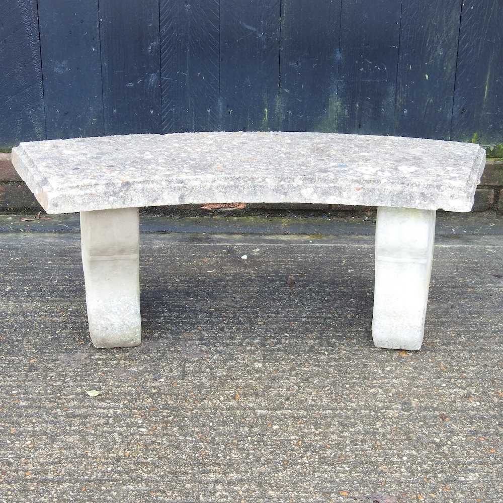 Lot 396 - A curved cast stone garden bench, 107cm
