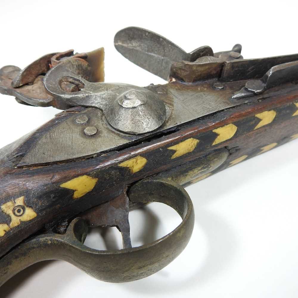 Lot 349 - A middle Eastern flintlock pistol, with bone