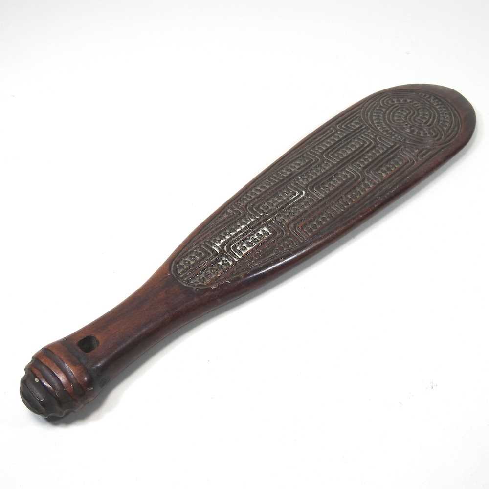 Lot 148 - A Maori hardwood short paddle, carved in low