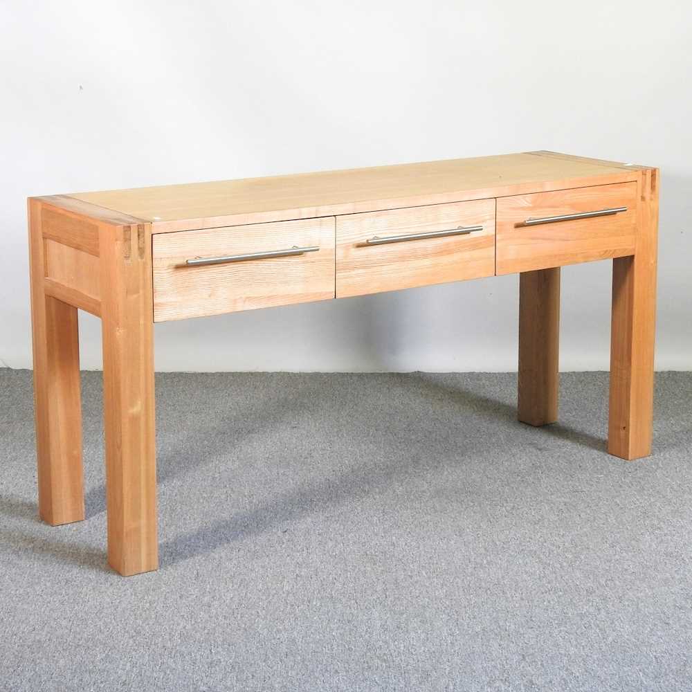 Lot 187 - A modern light oak console table, containing