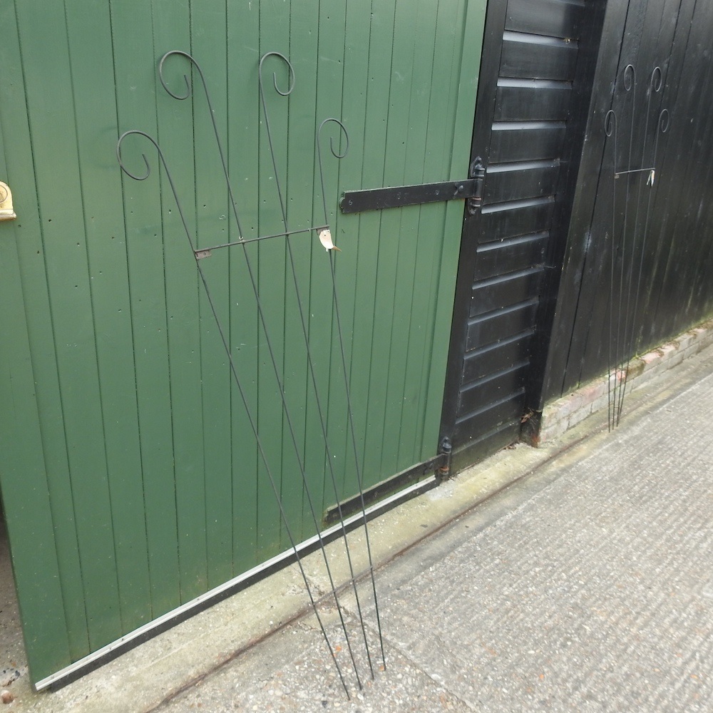Lot 340 - A pair of black painted metal garden spires