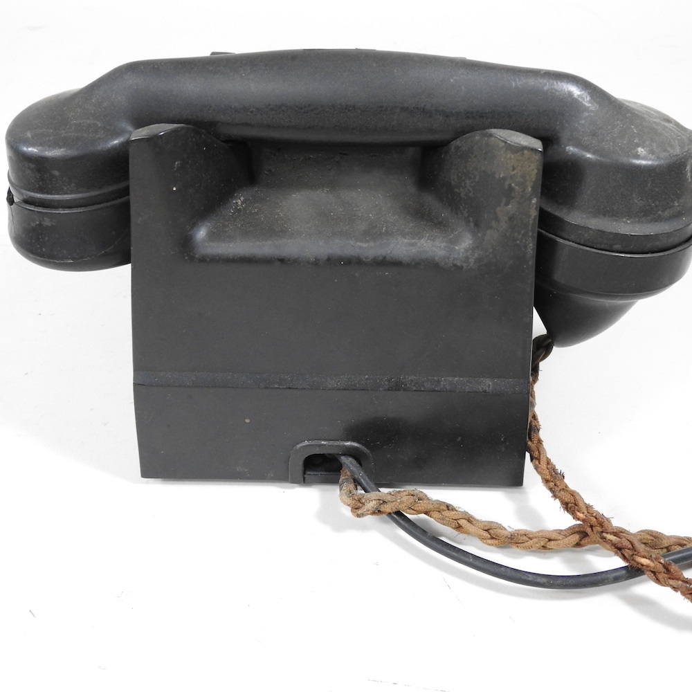 Lot 479 - A vintage black bakelite telephone, together