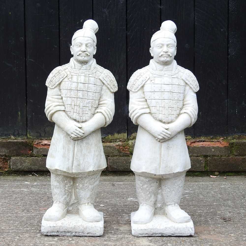 Lot 105 - A pair of cast stone garden statues of