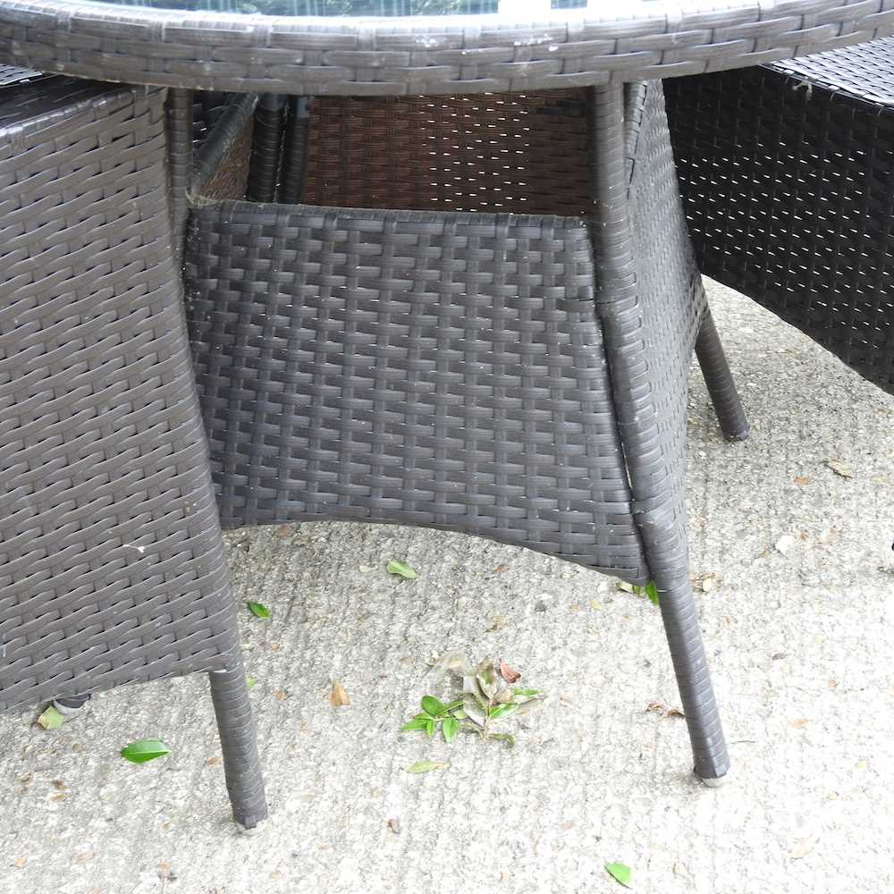 Lot 515 - A rattan black garden table, with a circular