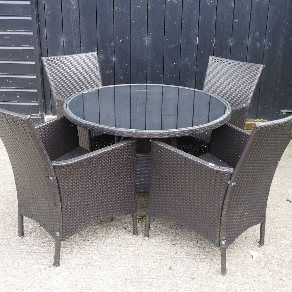 Lot 422 - A black rattan circular garden table, with a