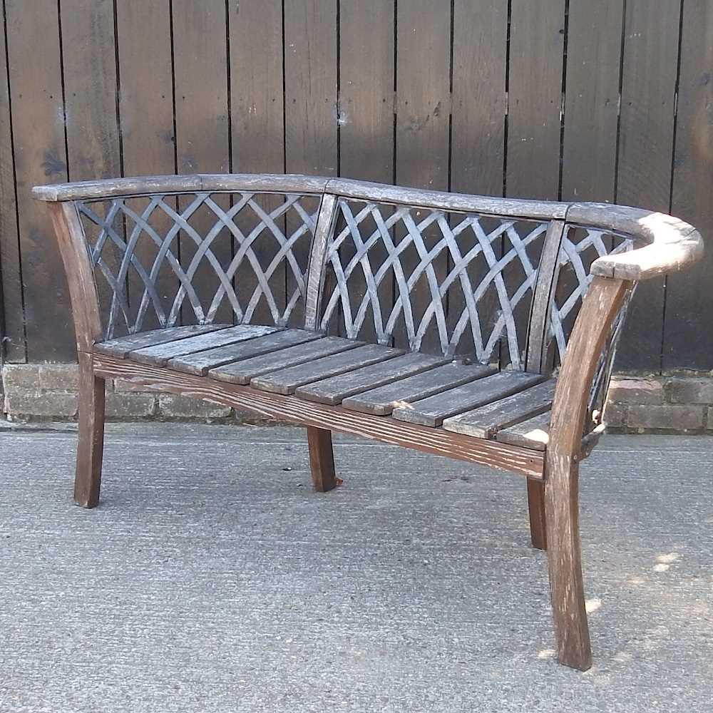 Lot 297 - A wooden garden bench, with a lattice back,
