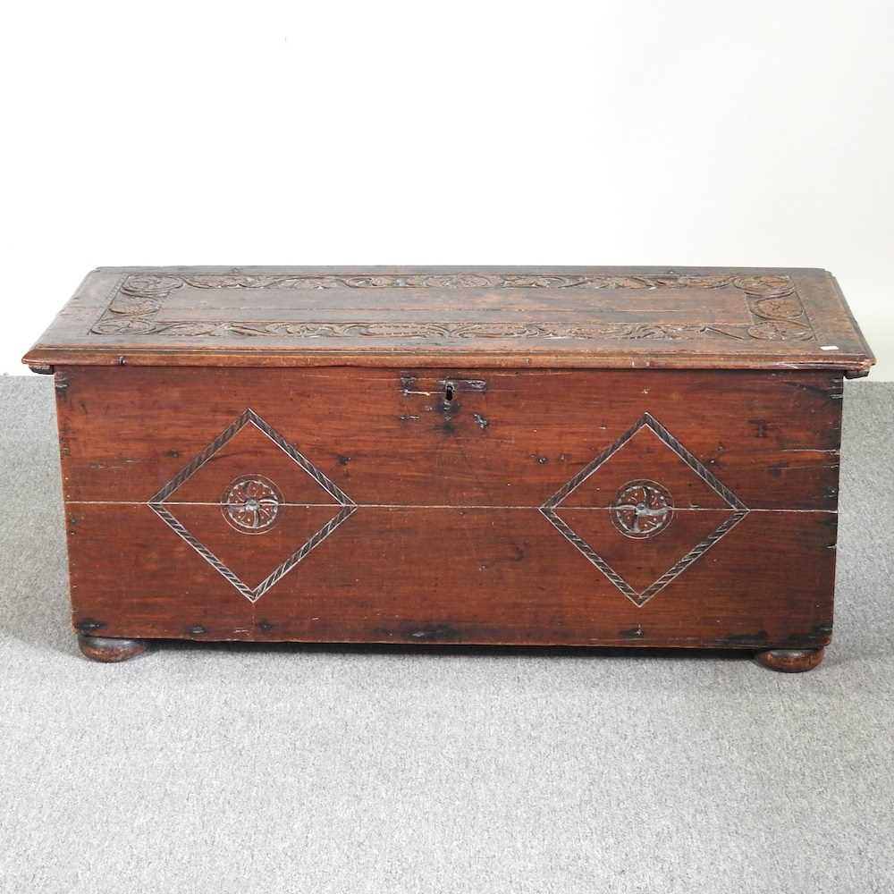 Lot 222 - An 18th century carved oak sword chest, with