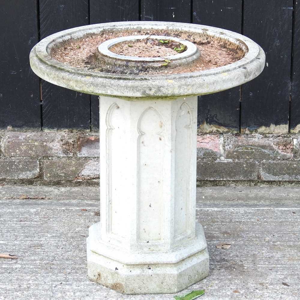 Lot 575 - A cast stone bird bath, with tracery