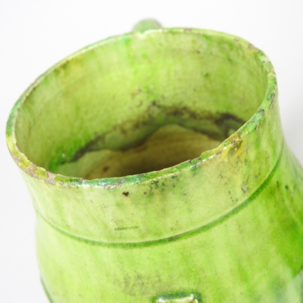 Lot 410 - A Castle Hedingham pottery green glazed mug,
