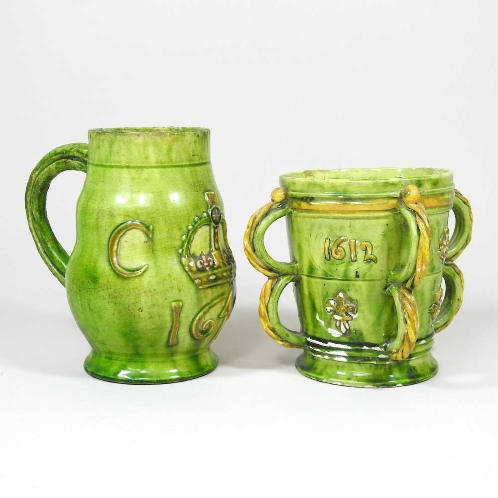 Lot 410 - A Castle Hedingham pottery green glazed mug,