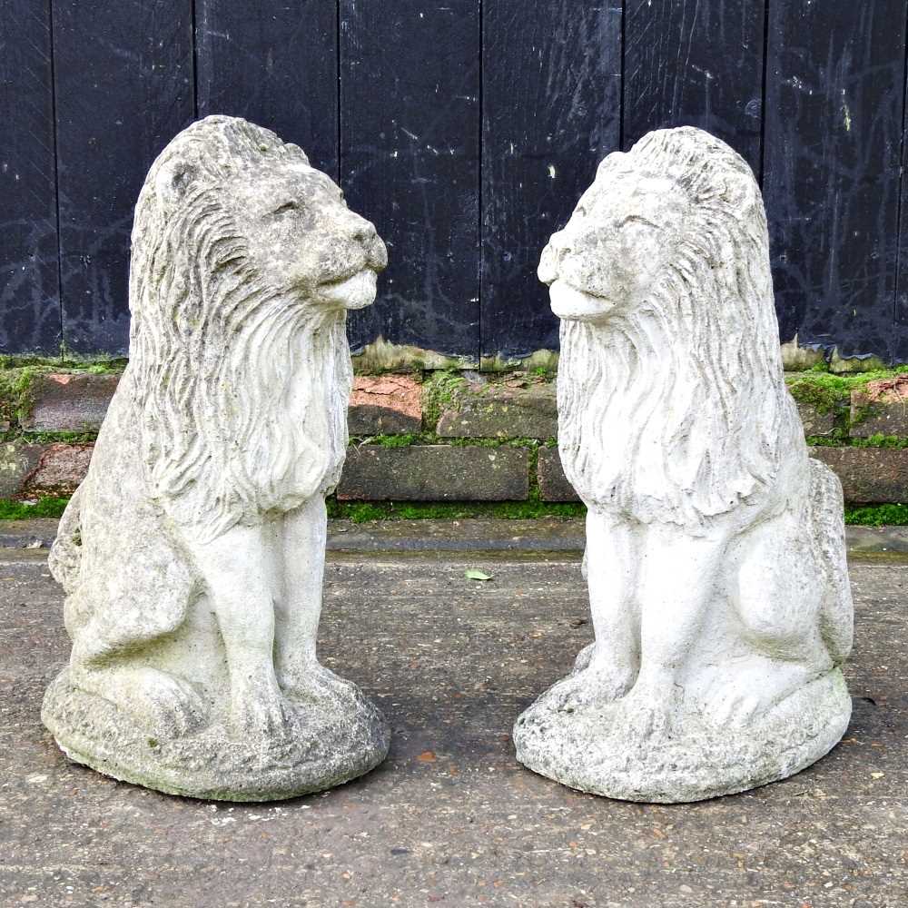 Lot 230 - A pair of cast stone garden statues of