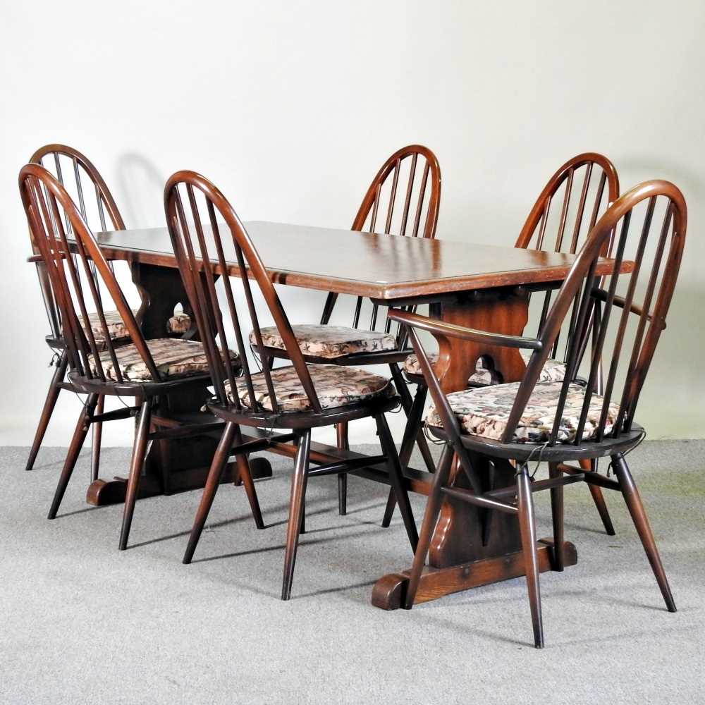 Lot 578 - A 1970's Ercol dark elm dining table,