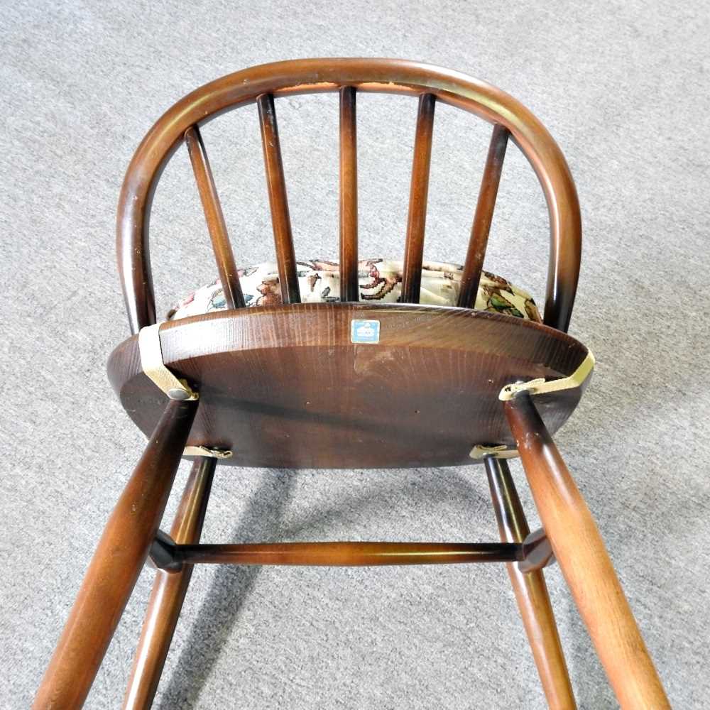 Lot 329 - A 1970's Ercol dark elm dressing table stool,