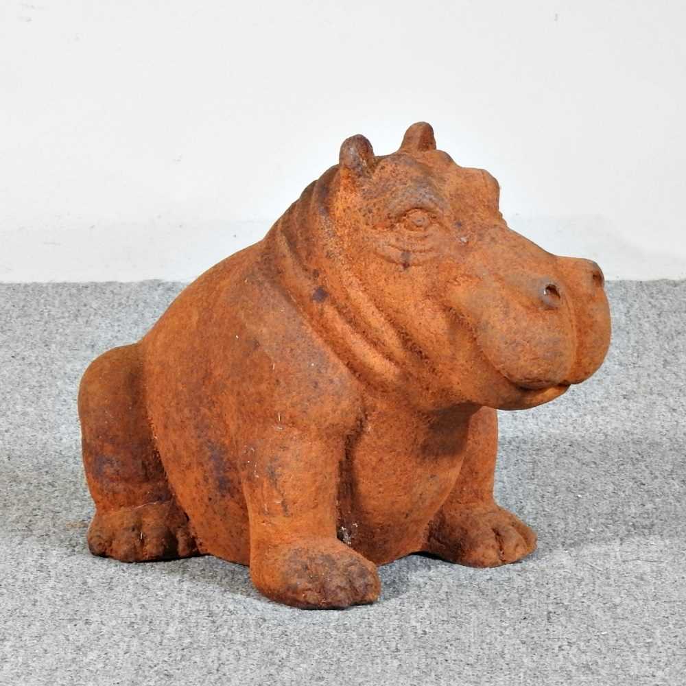 Lot 543 - A small rusted cast metal garden statue of a