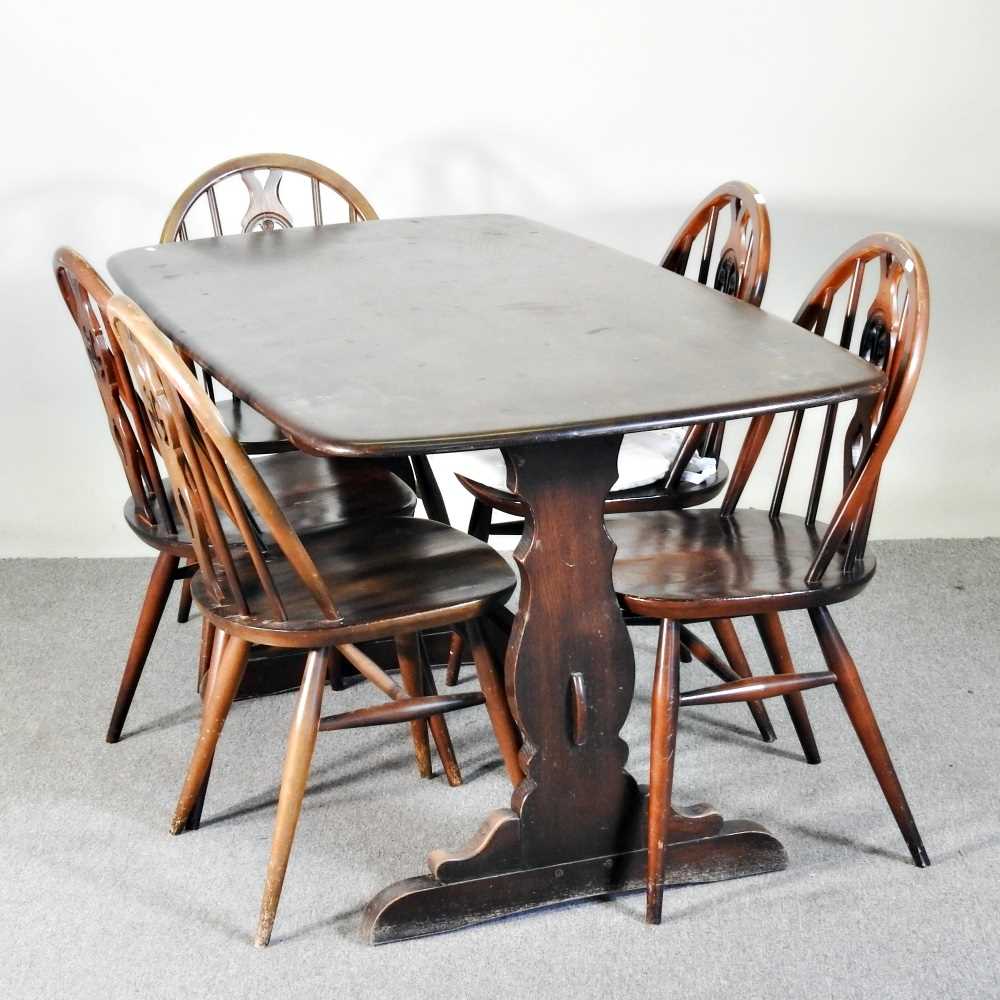 Lot 106 - A 1970's Ercol dark elm dining table,