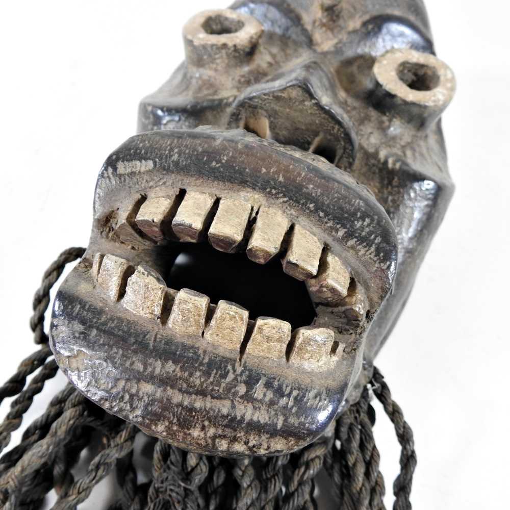 Lot 452 - An African carved wooden tribal mask,
