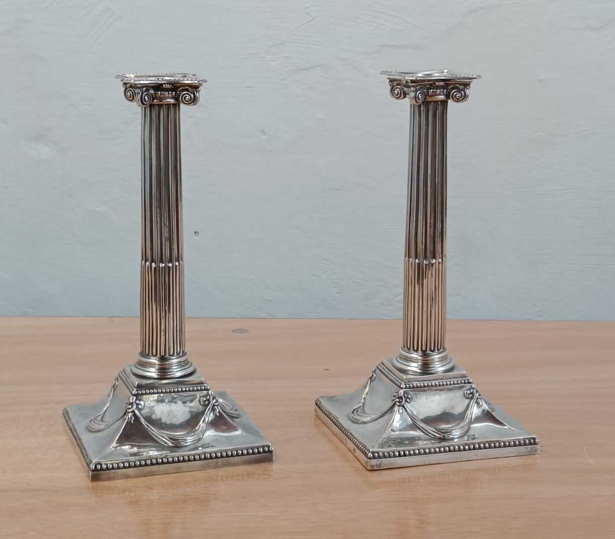 Lot 131 - A pair of George III silver candlesticks,