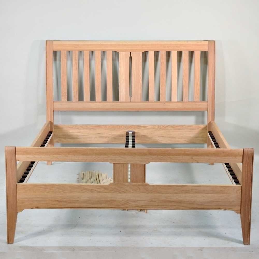 Lot 478 - A modern light oak double bedstead, with a