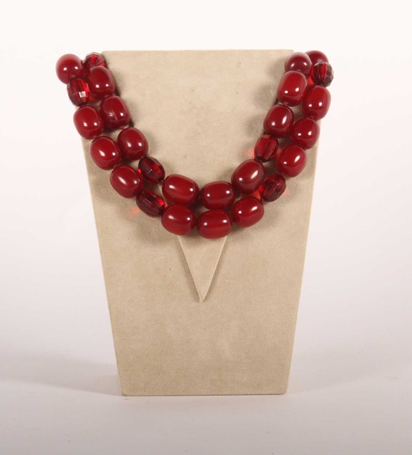 Lot 198 - A faux cherry amber barrel bead necklace and