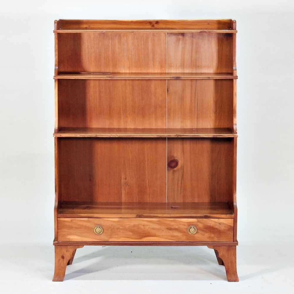 Lot 324 - A yew wood waterfall open bookcase