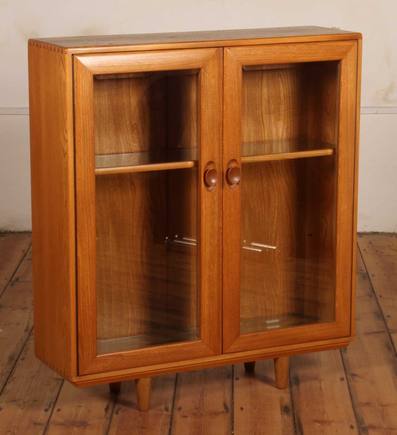 Lot 32 - An Ercol blonde elm Windsor glazed display