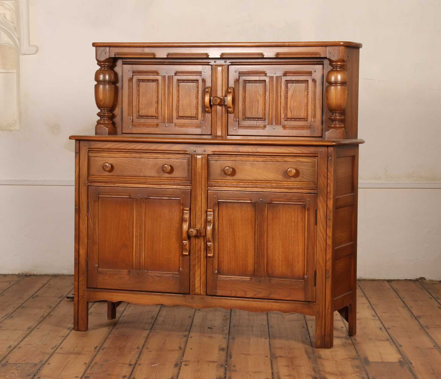Lot 368 - An Ercol elm court cupboard, enclosed by