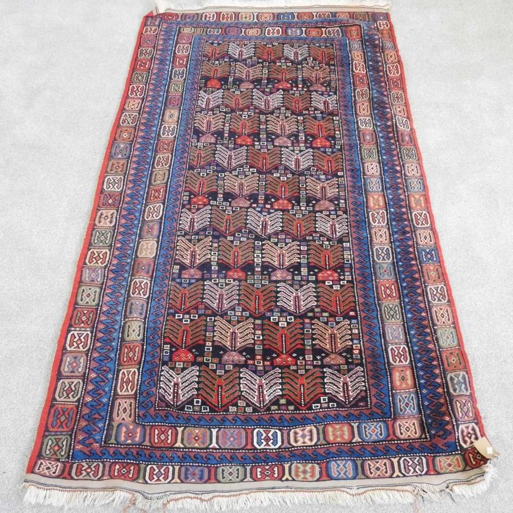 Lot 677 - A Baluch carpet, with coloured motifs,