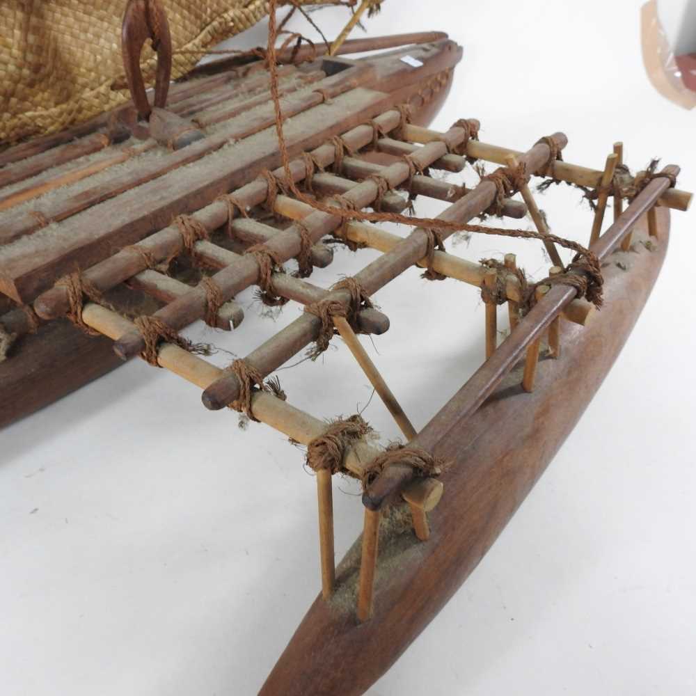 Lot 550 - A carved wooden model of a Samoa canoe, with