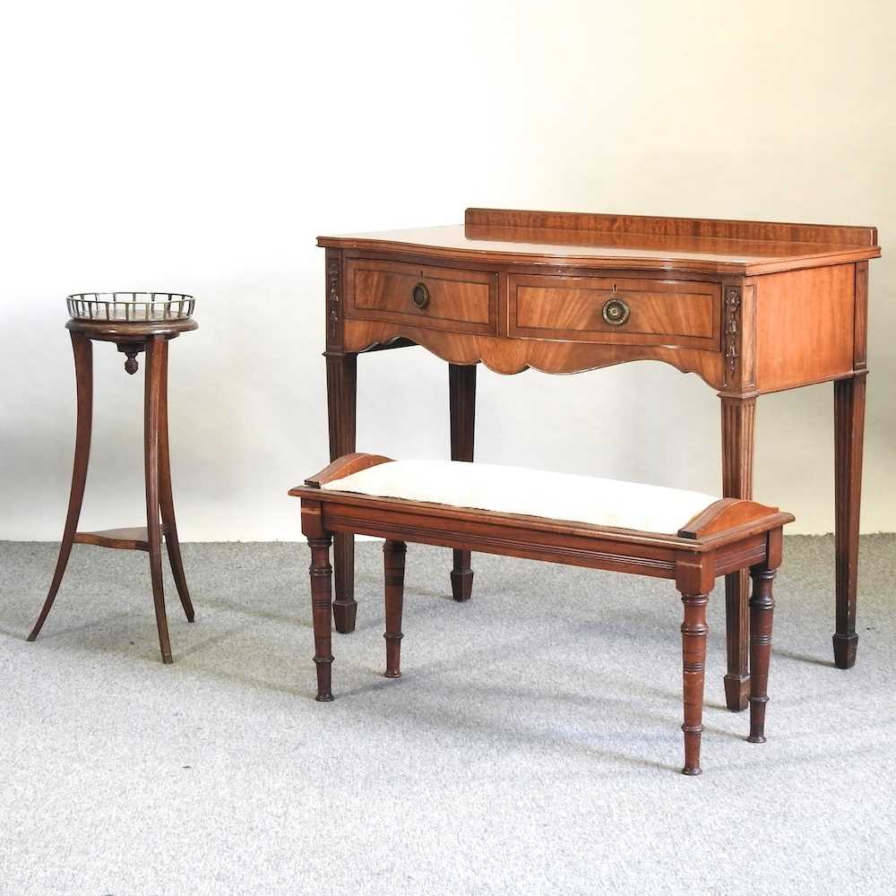 Lot 682 - A Regency style walnut serpentine side table