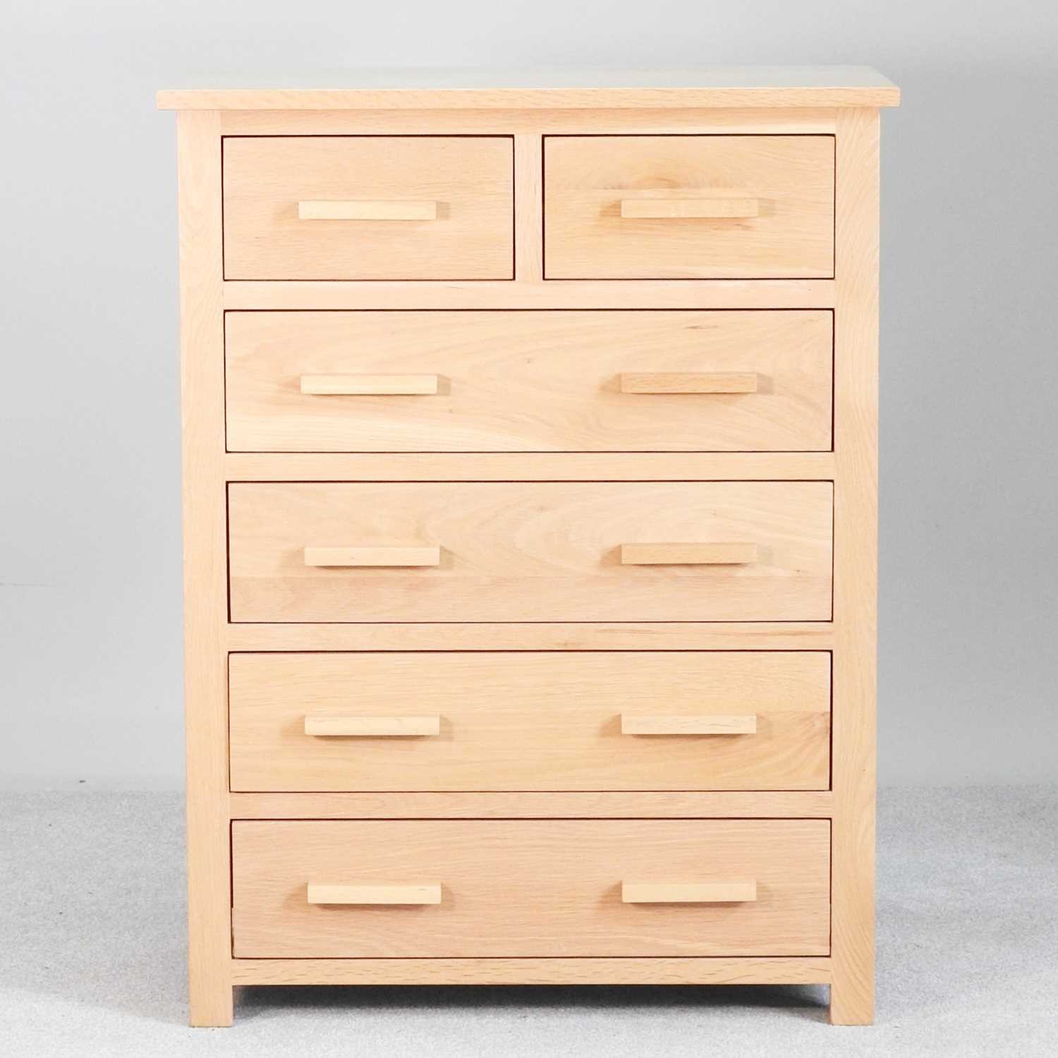 Lot 232 - A modern light oak chest of drawers