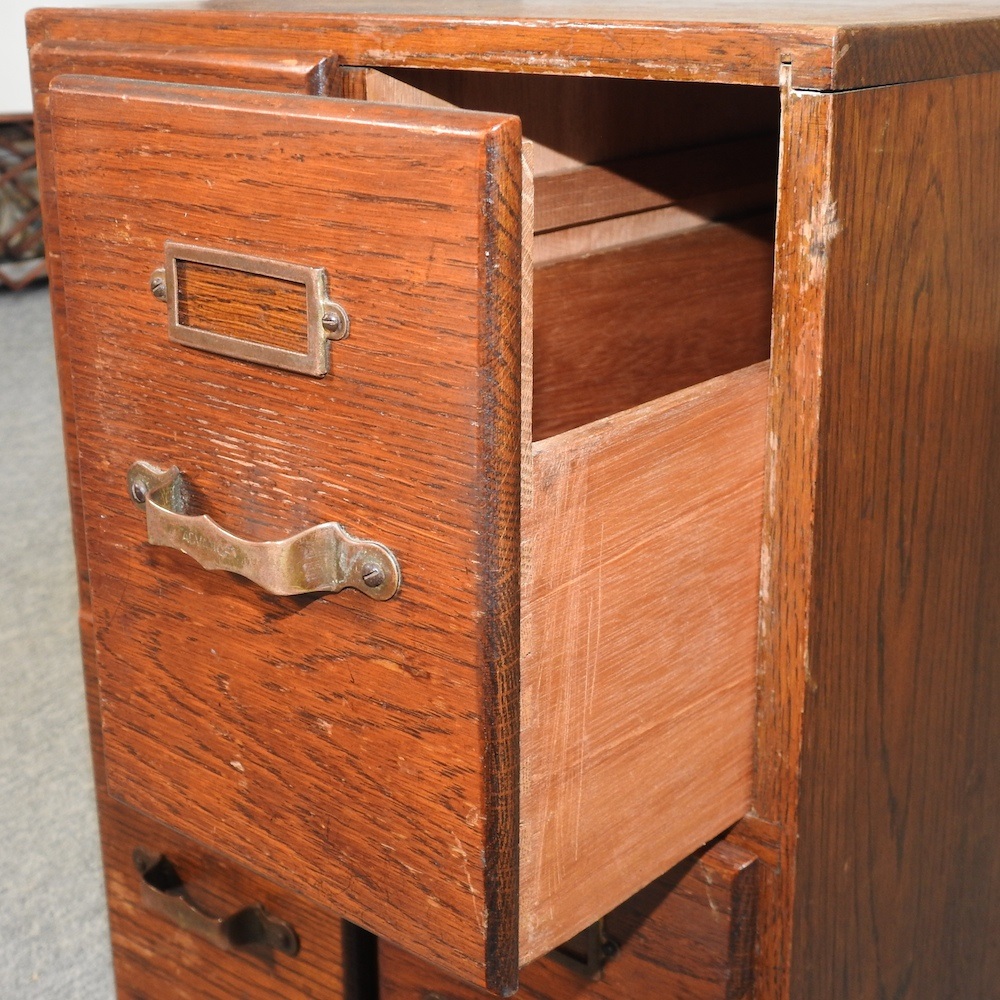 Lot 707 - An early 20th century oak filing cabinet