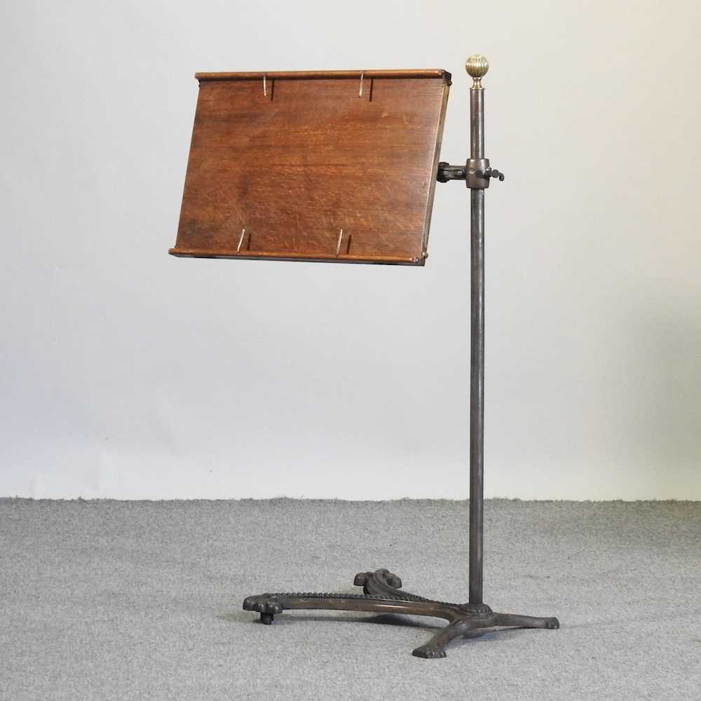 Lot 571 - An early 20th century oak and iron reading