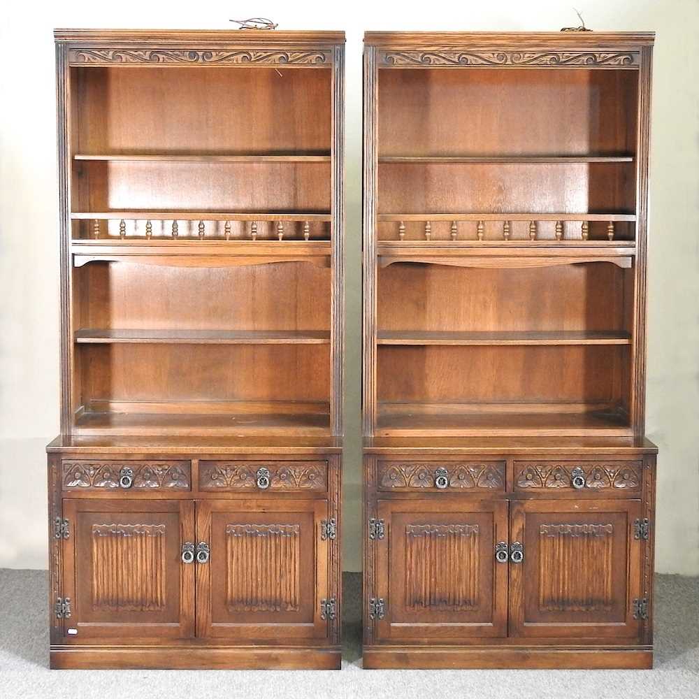 Lot 450 - A pair of Old Charm style oak bookcases